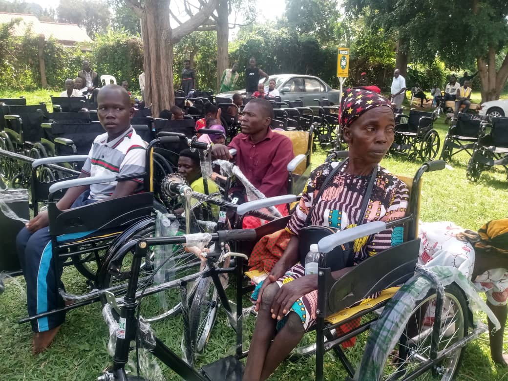 Minister Oboth Helps Distribute Tricycles and Wheelchairs to PWDs in Tororo